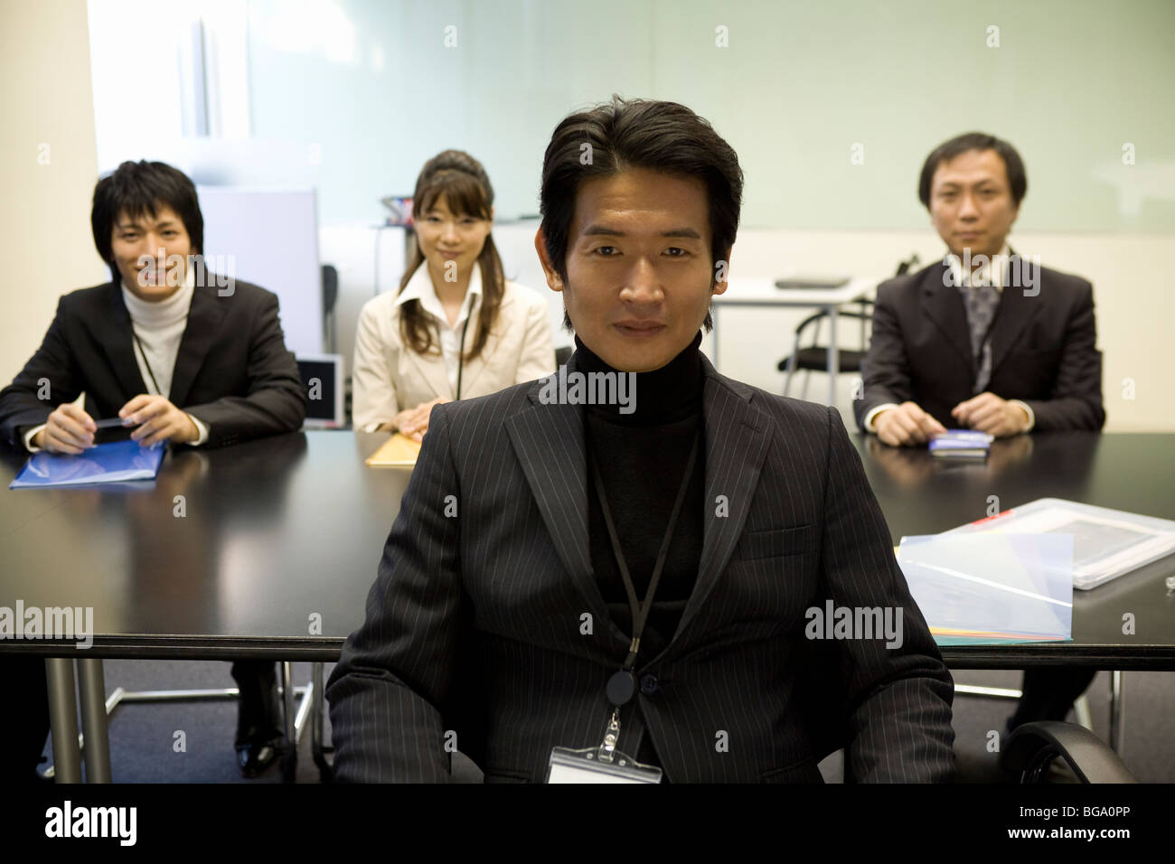 Four people meeting at table Stock Photo - Alamy