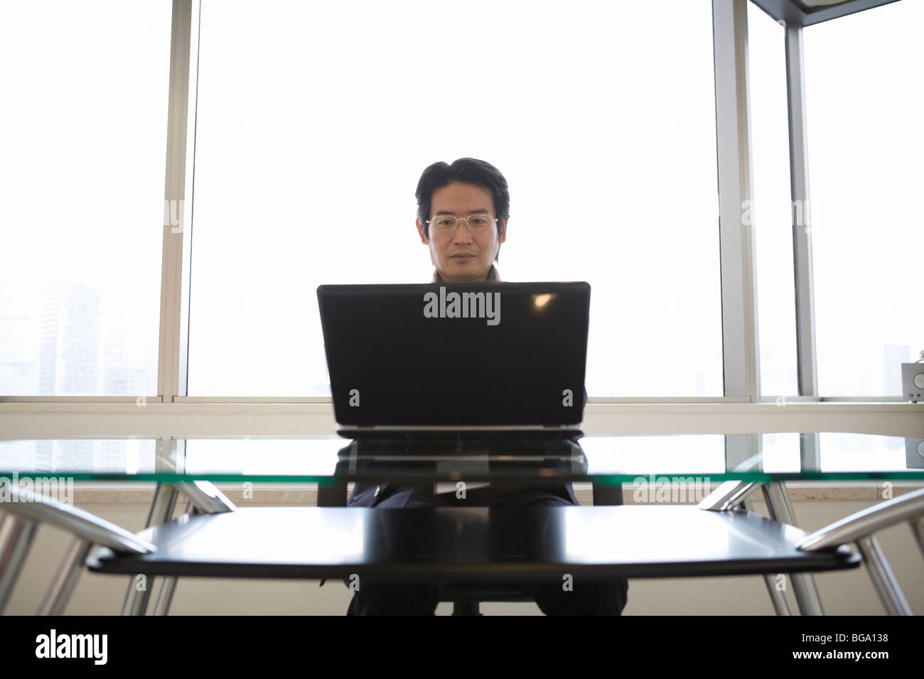 Mature man looking at computer monitor Stock Photo - Alamy