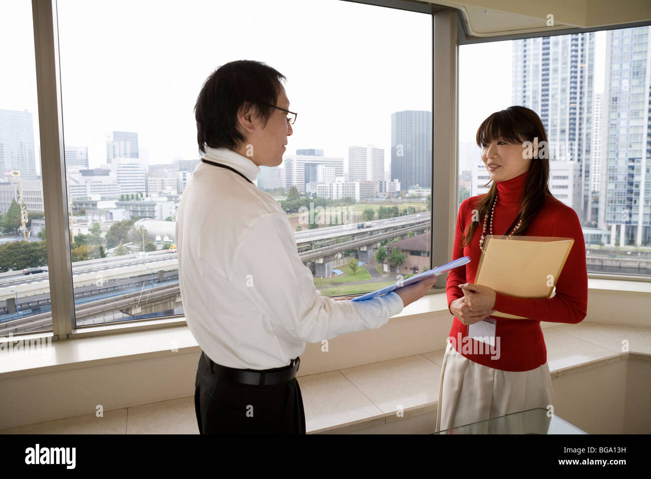 Two person meeting by the window Stock Photo - Alamy