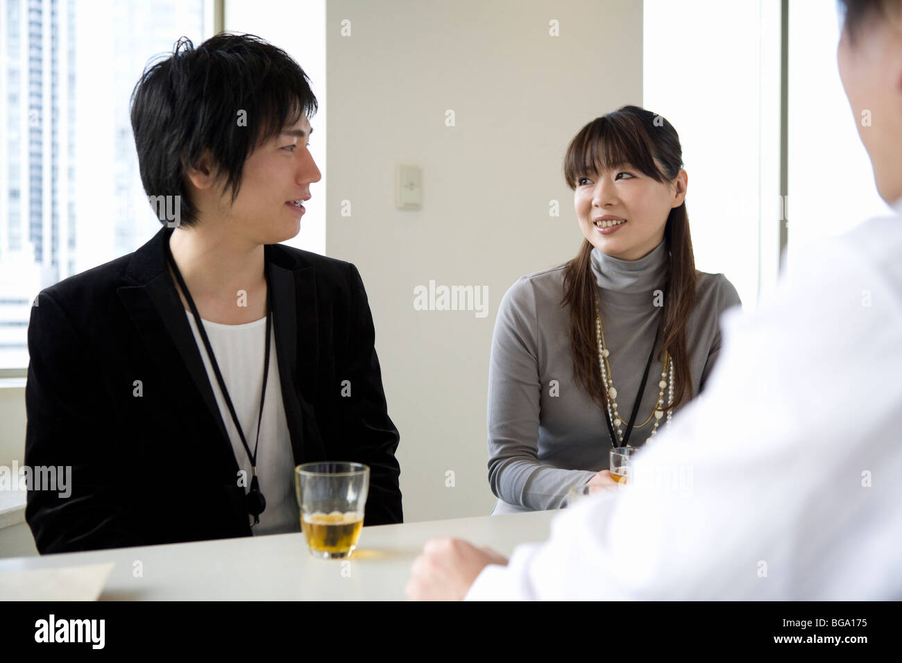Three people meeting at table Stock Photo - Alamy