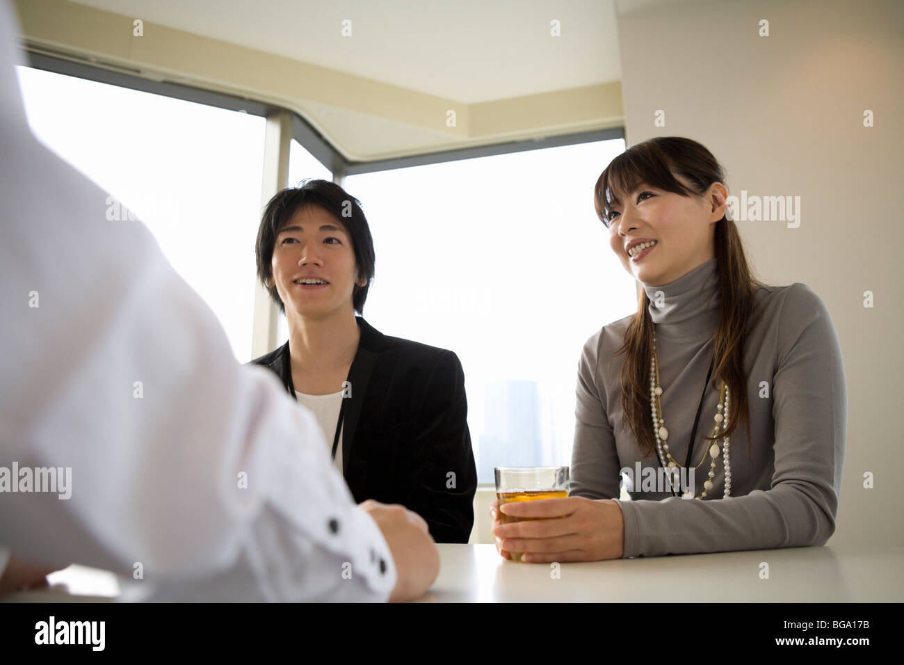 Three people meeting at table Stock Photo - Alamy