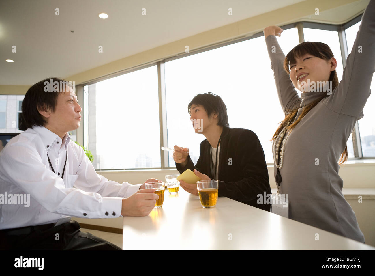 Three people having a break in office Stock Photo - Alamy