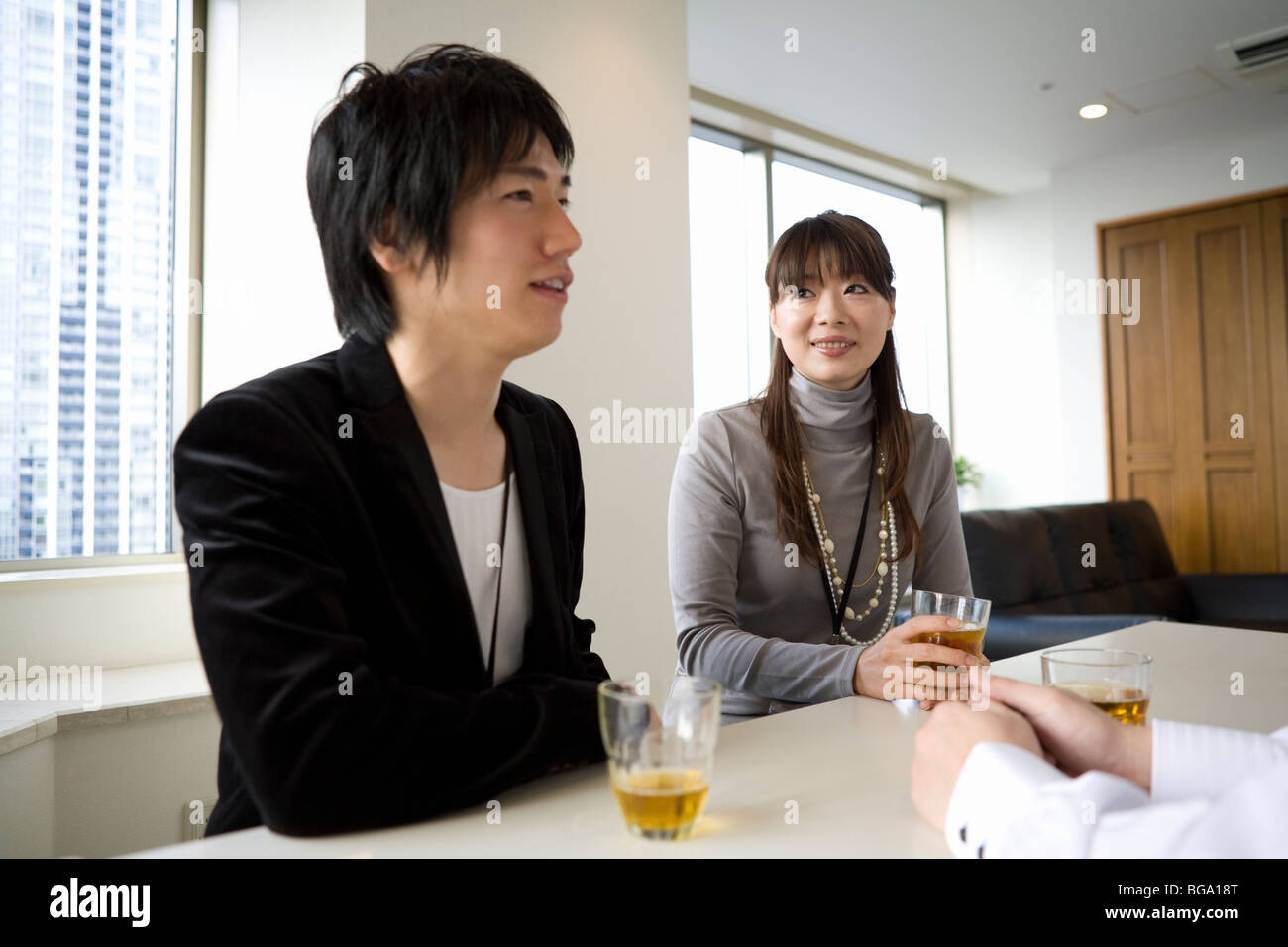 Three people meeting at table Stock Photo - Alamy