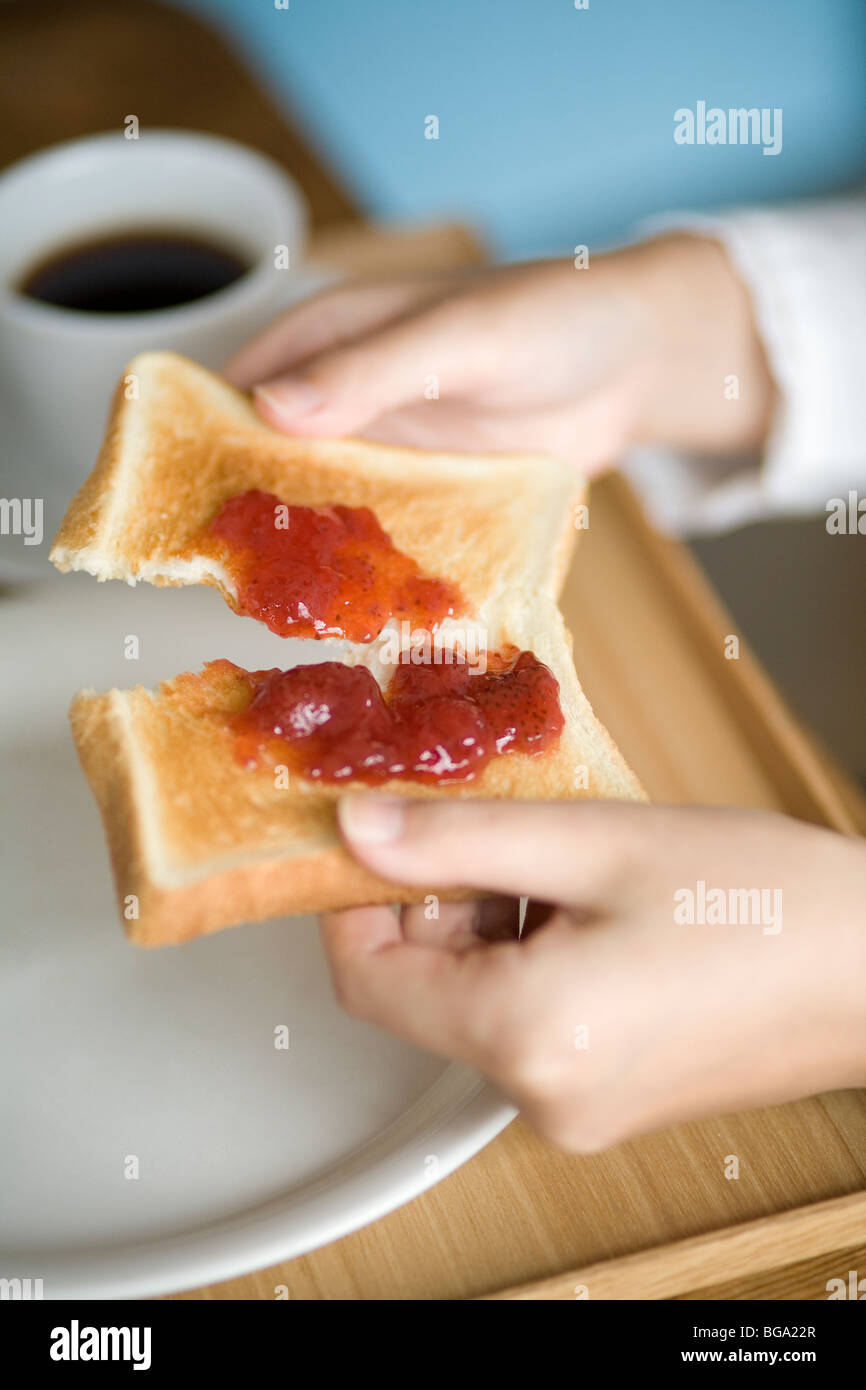 Hand holding plate jam bread hi-res stock photography and images - Alamy