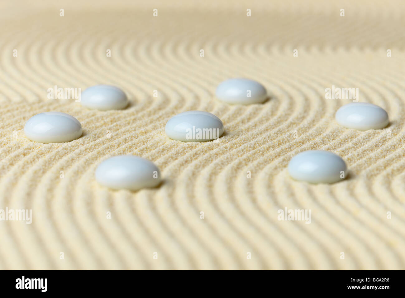 White drops on a surface of yellow sand - an abstract composition Stock ...