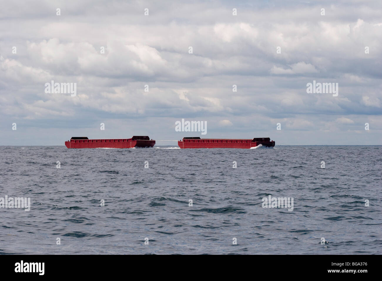 Two barges in tow behind the Tugboat TREASURE COAST Stock Photo - Alamy