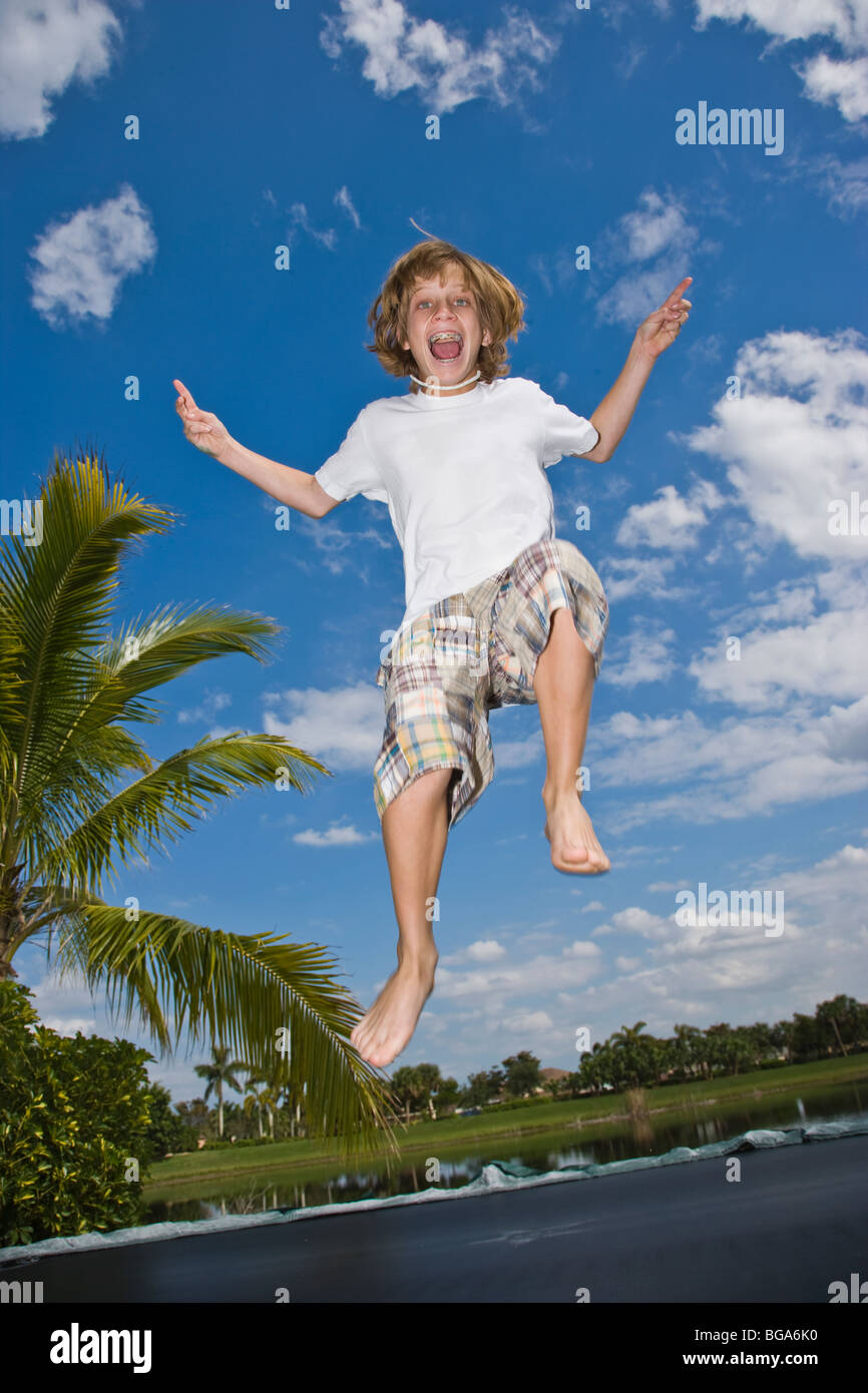 Portrait of boy (12-13) leaping, outdoors, Weston, Florida, USA Stock ...
