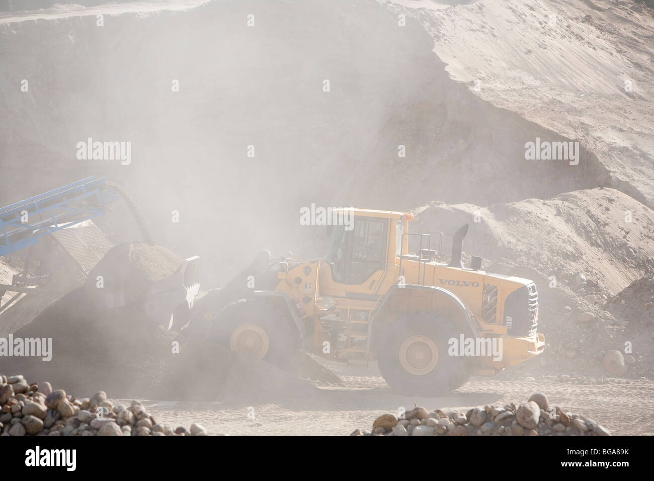 Front loader moving sand in a sandpit at sand quarrying area , Finland ...