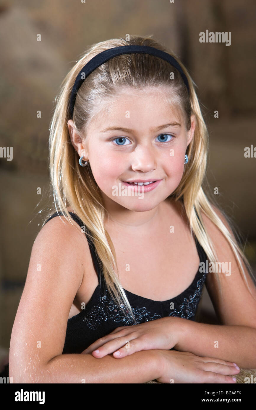 Blond girl with hair band, smiling, portrait Stock Photo - Alamy