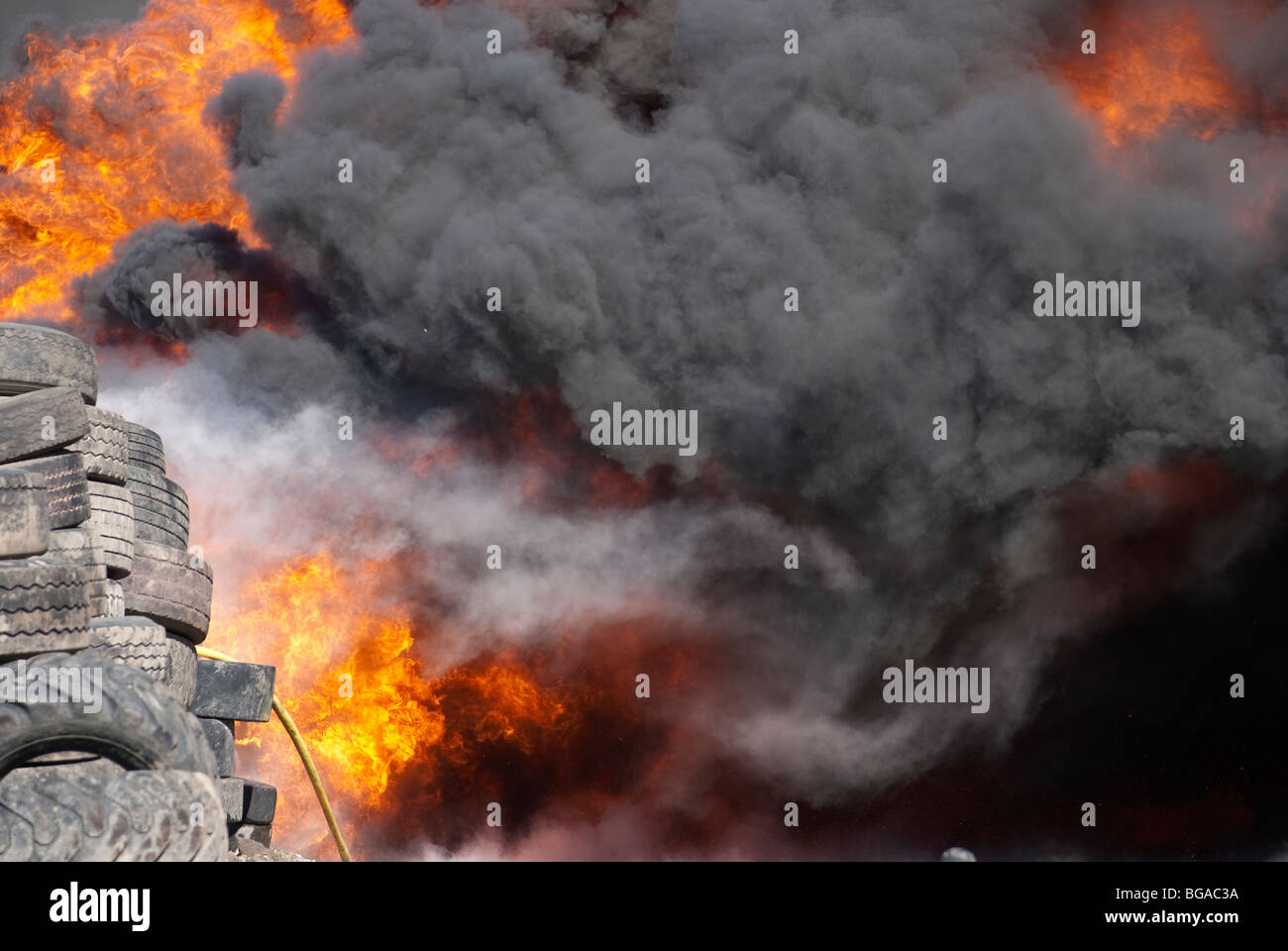 Large plumes of black smoke from large Tyre Factory fire Stock Photo ...