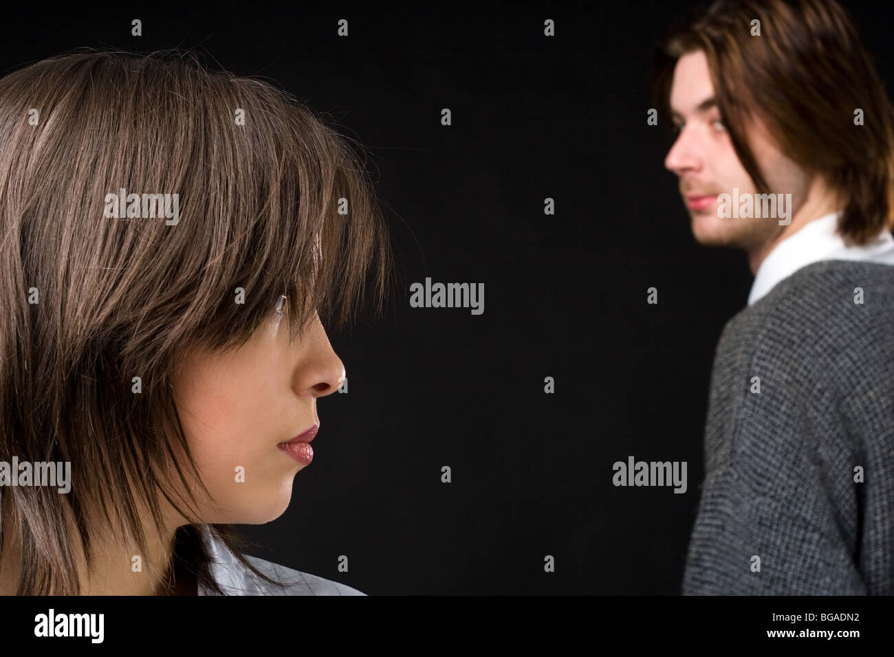 young man and beautiful young girl glance against each other Stock ...