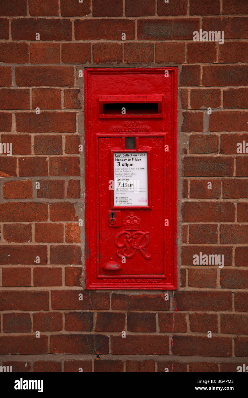 Red GR post-box set into a brick wall on the side of a building Stock ...