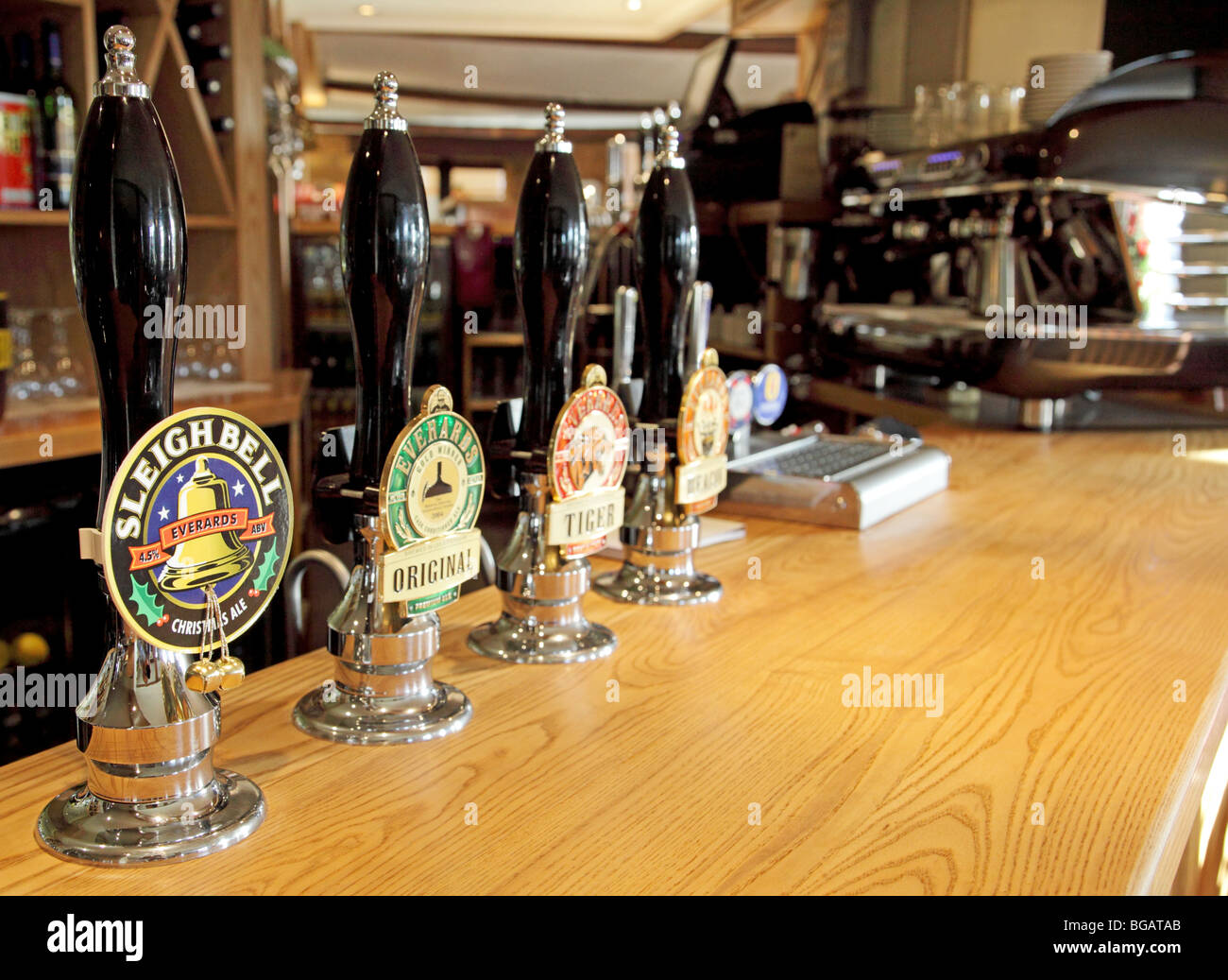 A row of traditional beer pumps in a modern pub, with an espresso ...