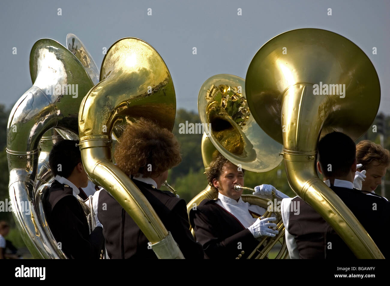 Tuba players from a college marching band warming up before a football ...