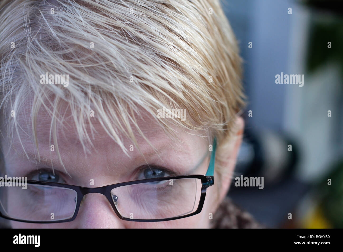 Woman looking over the rim of her glasses hi-res stock photography and ...