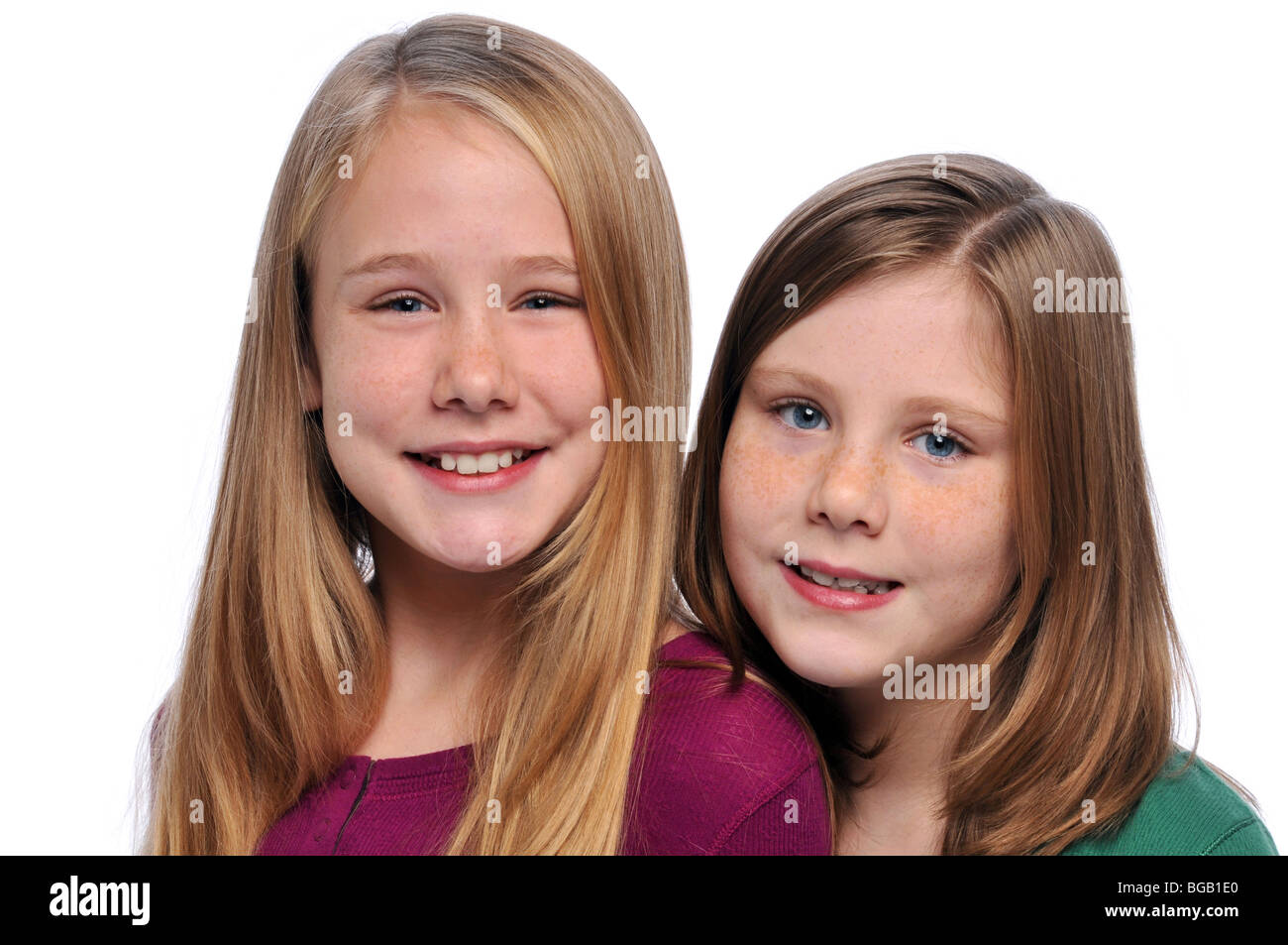 Two sisters smiling isolated on a white background Stock Photo - Alamy