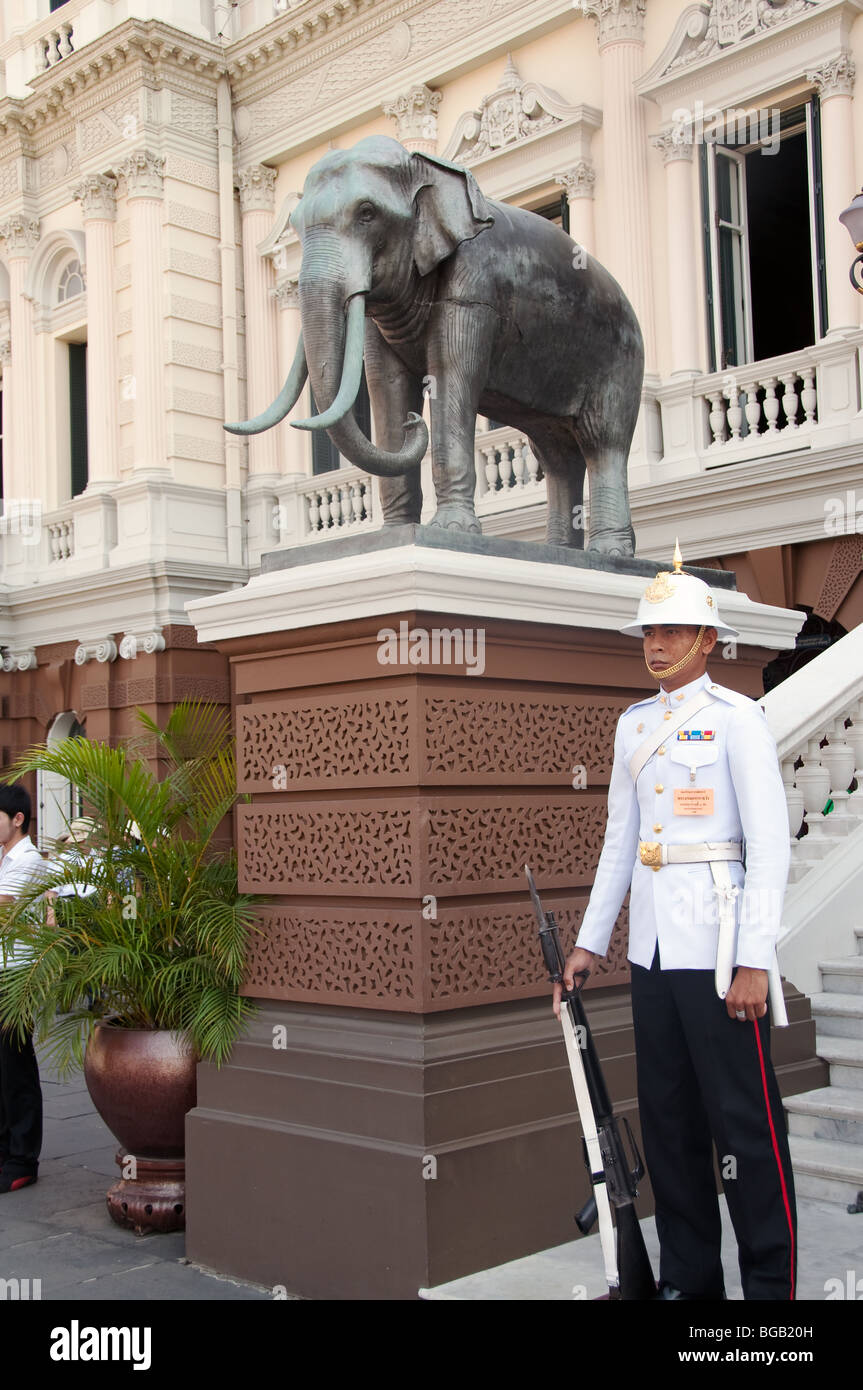 guard in traditional garb outside the grand palace in bangkok, thailand ...