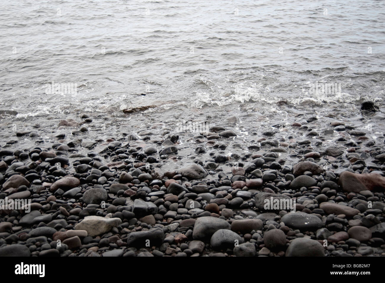 Shoreline; Water Splashing Against Rocks Stock Photo - Alamy