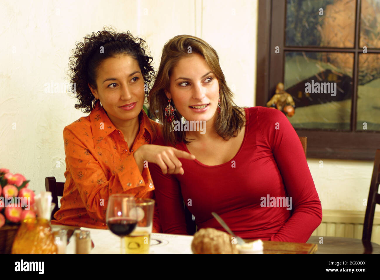 Female friends gossiping in restaurant Stock Photo - Alamy