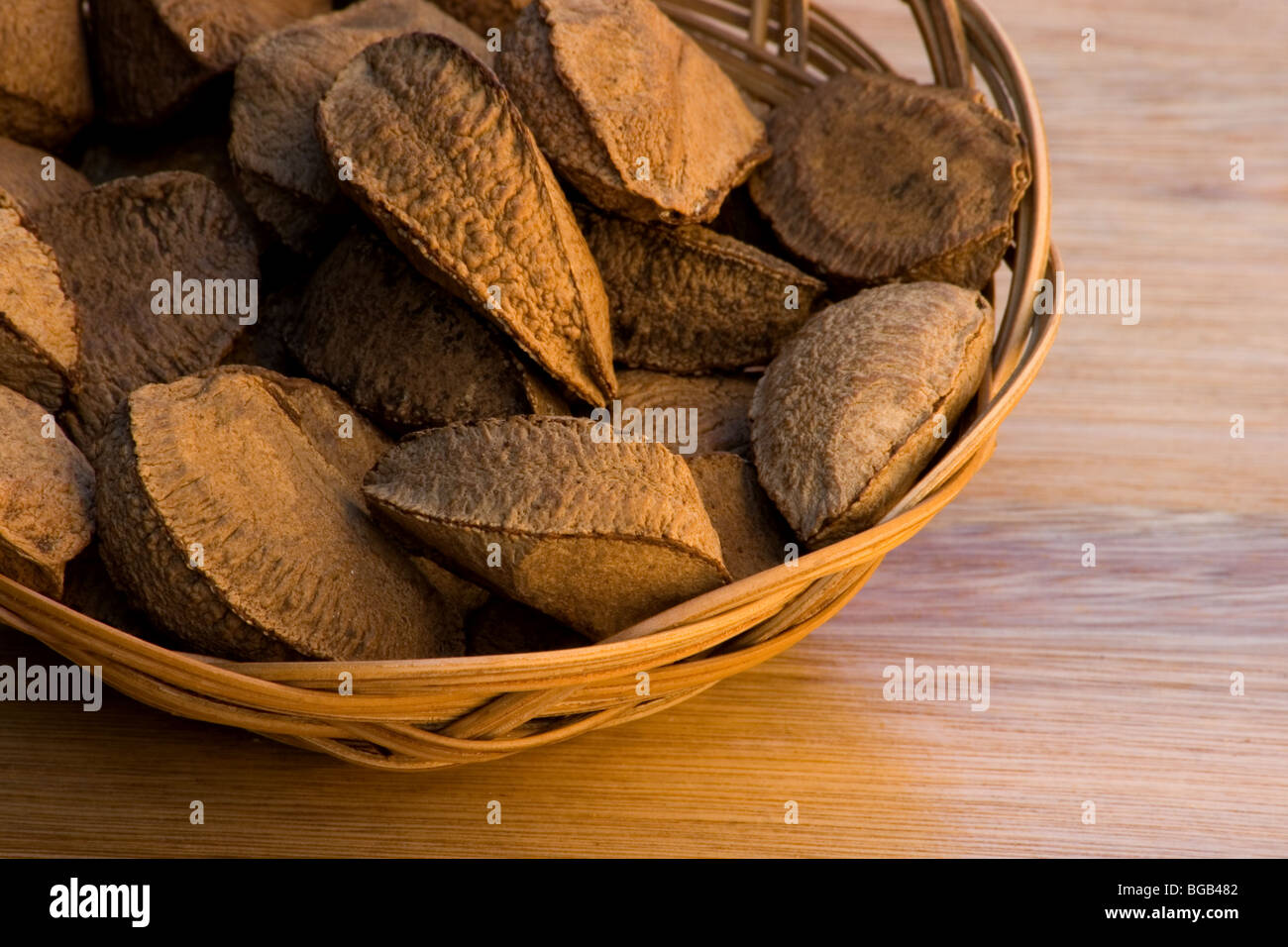 Brazil nuts in a basket on wooden background Stock Photo - Alamy