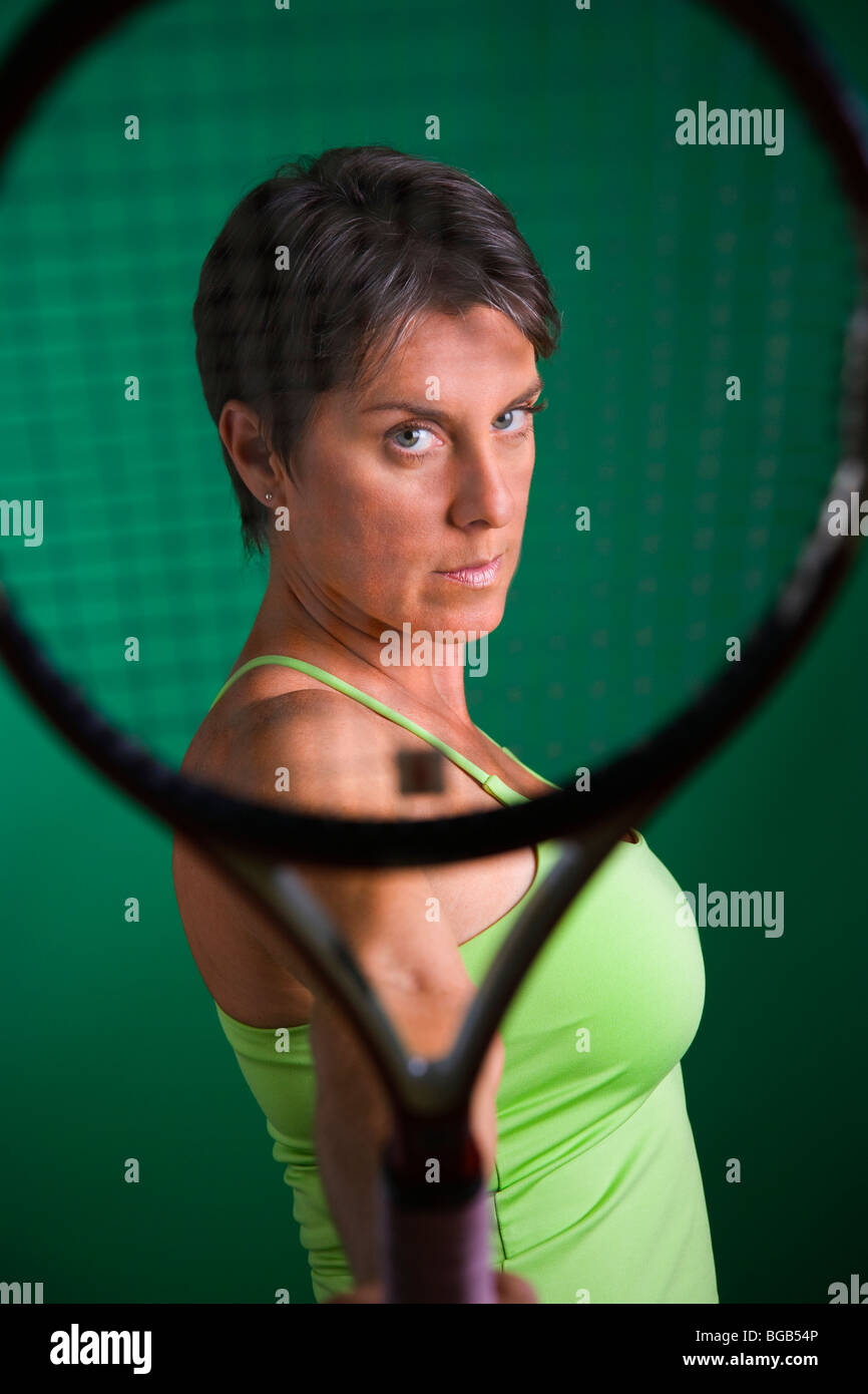 Woman portrait seen through tennis racquet Stock Photo - Alamy