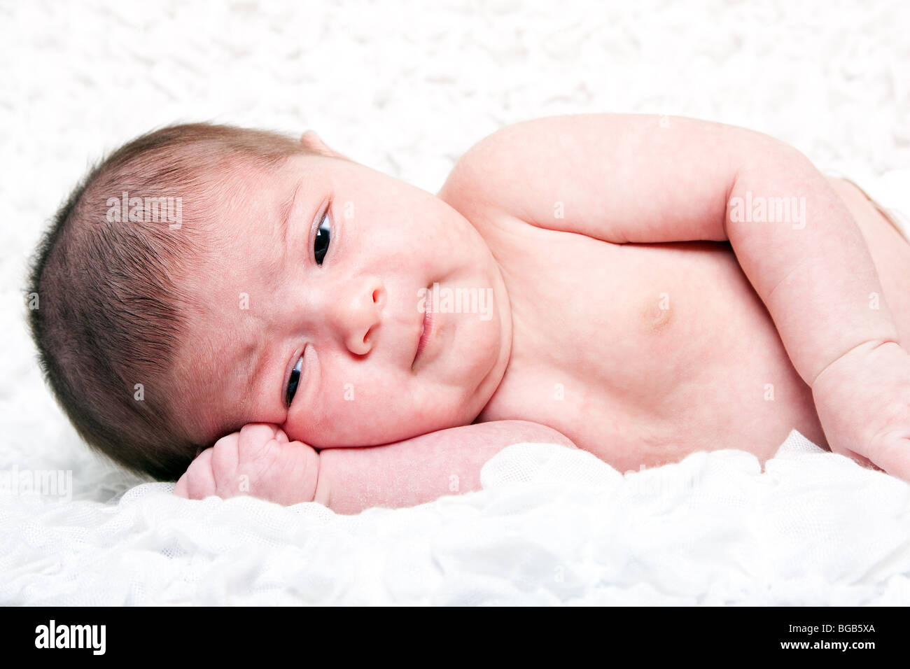 Beautiful cute Caucasian Hispanic infant baby laying on her side on a ...