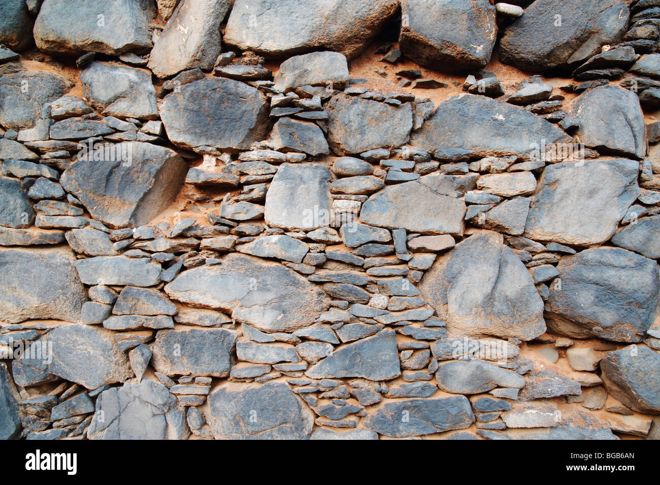 High wall built with different sized rocks and mud around saltworks ...