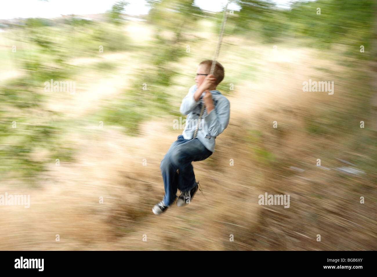 boy swinging on a rope Stock Photo - Alamy