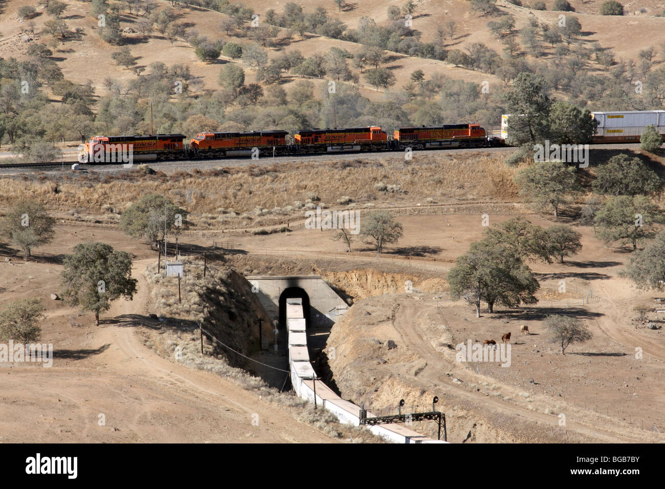 An eastbound BNSF freight train climbs and passes over itself at the Tehachapi Loop between ...