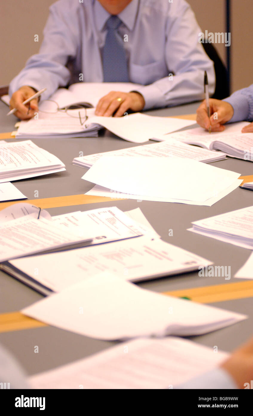 Royalty free photograph of business meeting with papers and hands in ...