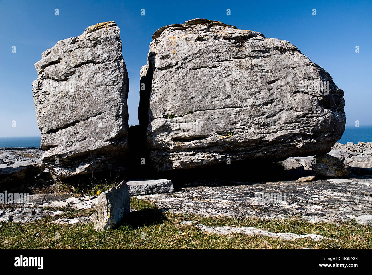 Ireland, County Clare, The Burren, large limestone boulder split into ...