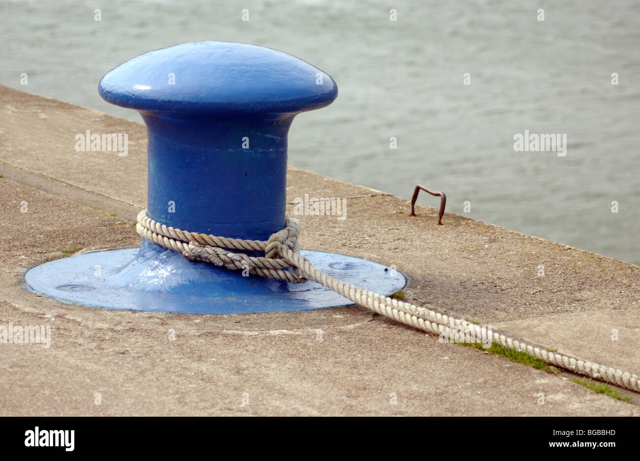 Royalty free photograph of bollard with rope tied to it at a dock in UK ...
