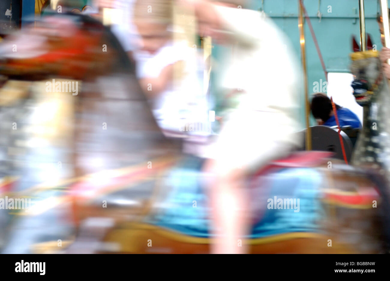 Royalty free photograph of kids having fun on a merry go around very ...
