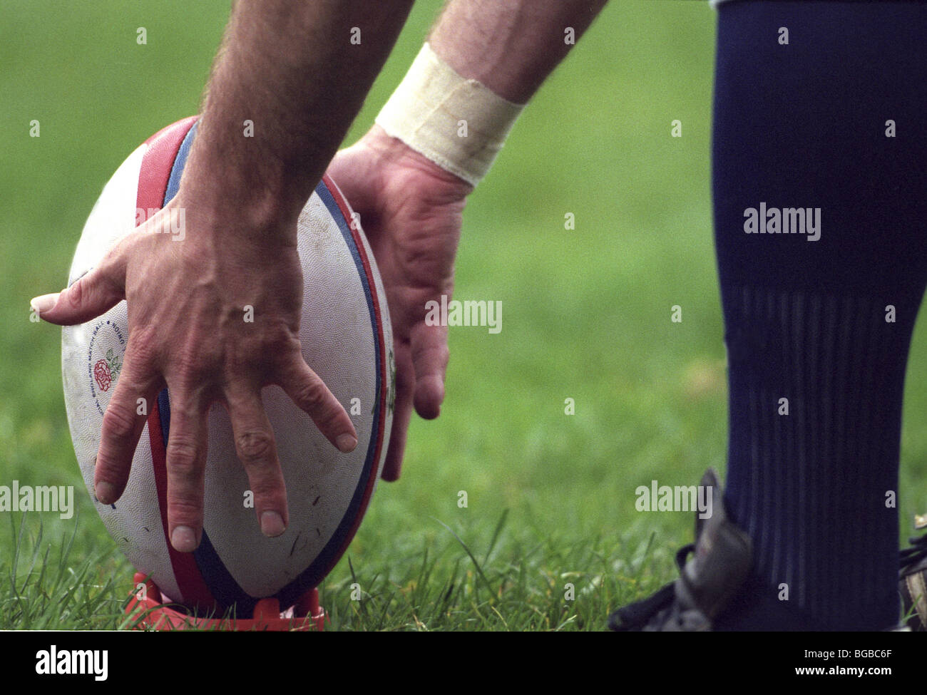 Rugby player placing the ball for a kick Stock Photo - Alamy