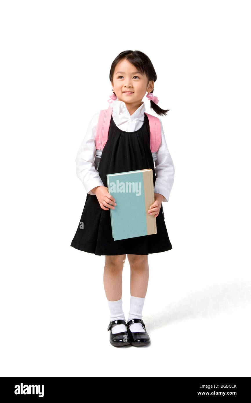 Little girl carries a book Stock Photo - Alamy