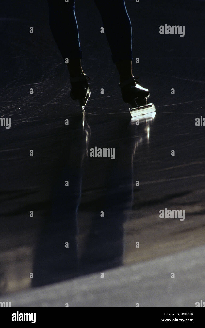 Low profile of a speed skater on black ice Stock Photo - Alamy