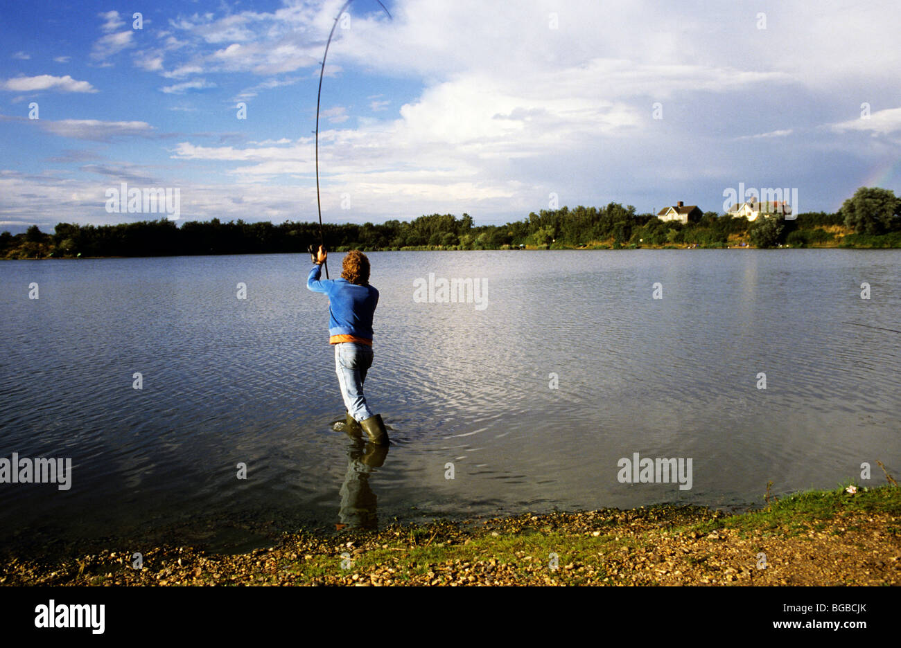 Man casting his fishing rod Stock Photo - Alamy