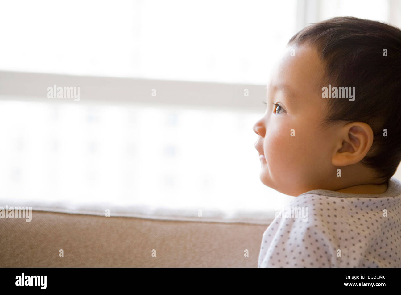 Infant in front of window Stock Photo - Alamy