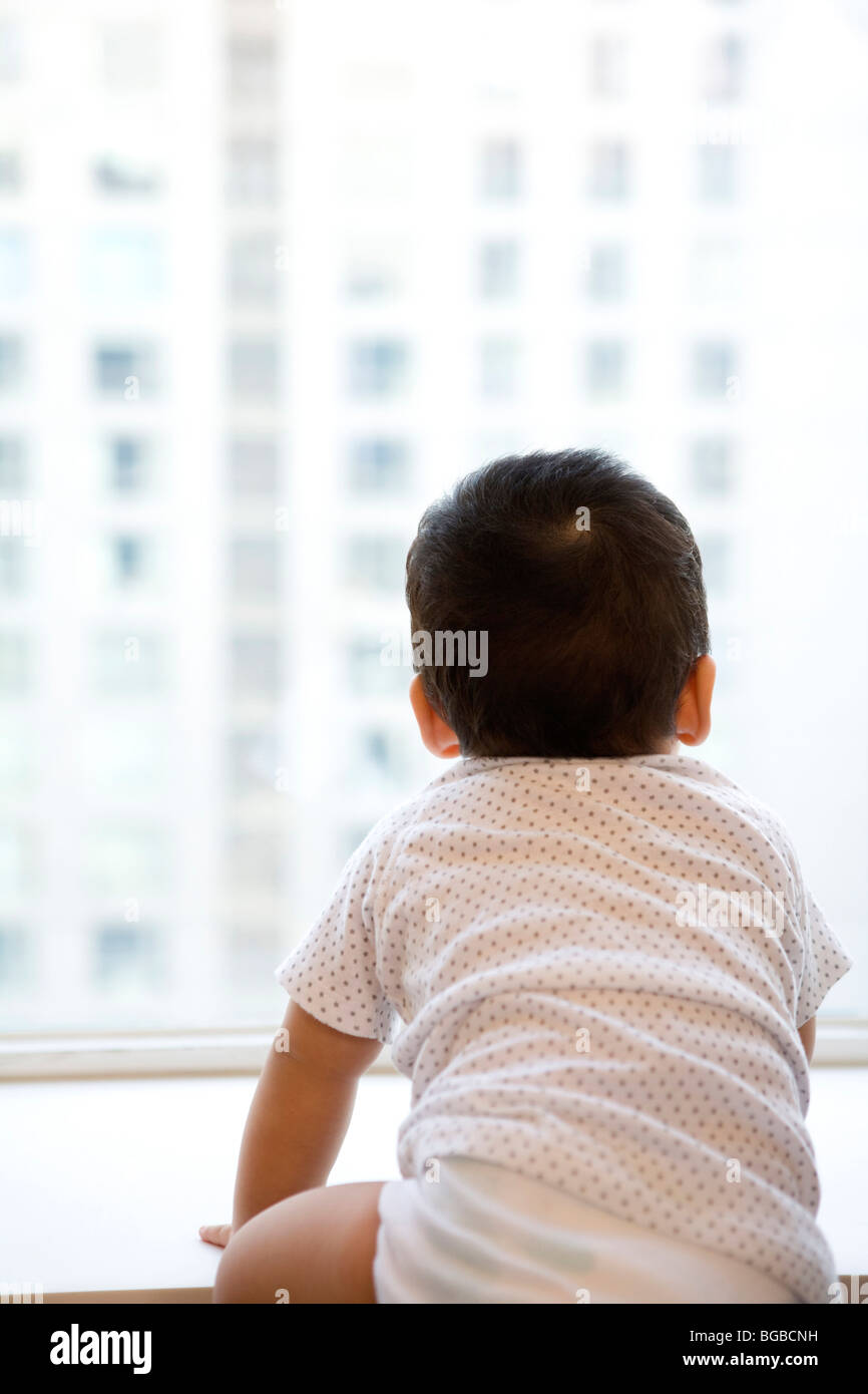 Infant looking out window Stock Photo - Alamy