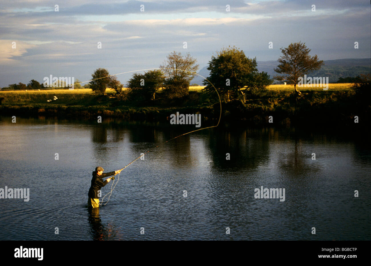 Man casting his fishing rod Stock Photo - Alamy