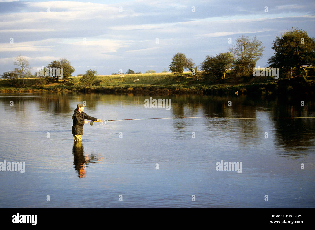 Man casting his fishing rod Stock Photo - Alamy