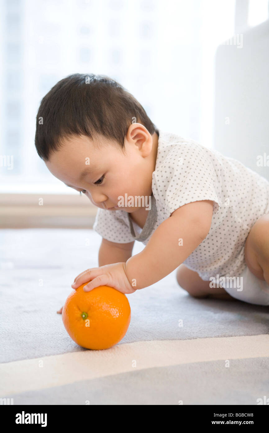 Infant with fruit Stock Photo - Alamy