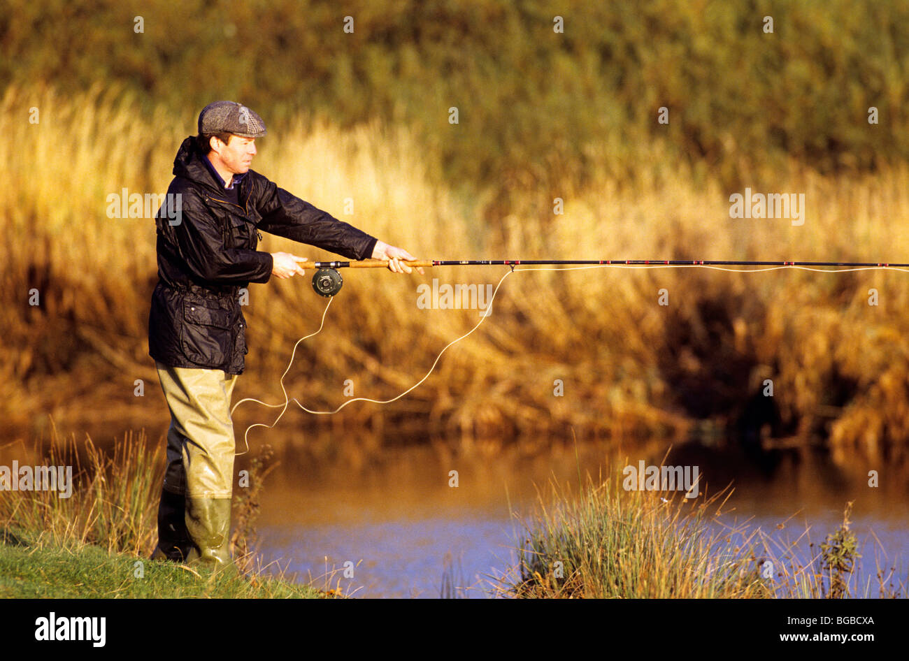 Man fly fishing Stock Photo - Alamy
