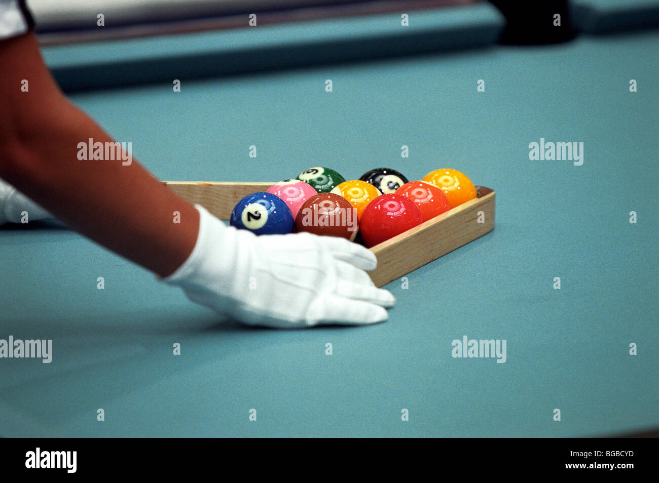 Referee sets up the rack of pool balls Stock Photo - Alamy