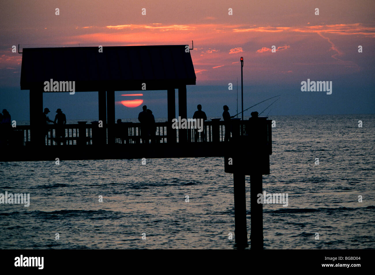 Silhouette of a group pier fishing Stock Photo - Alamy