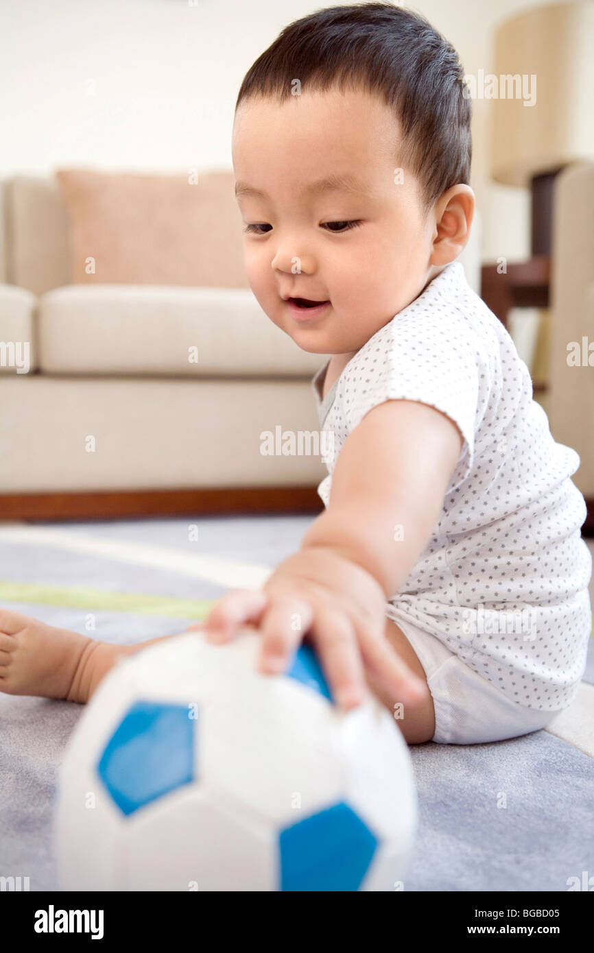 Infant with soccer ball Stock Photo - Alamy
