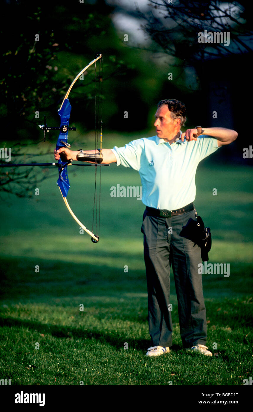 Male archer releasing arrow at a target Stock Photo - Alamy