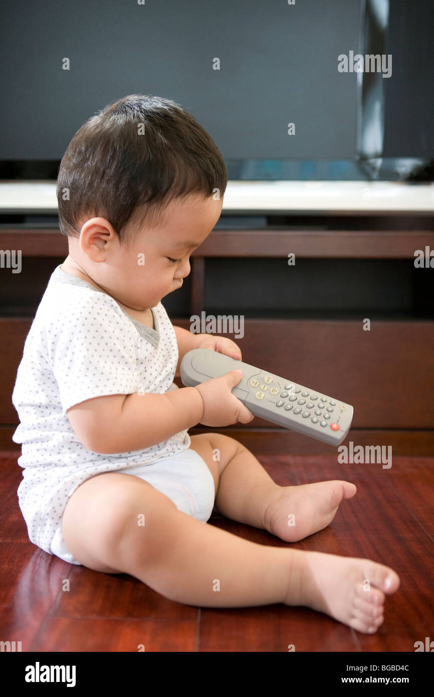Infant with remote Stock Photo - Alamy