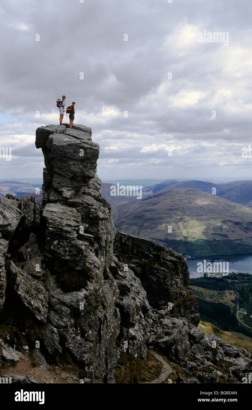 Hill walkers on top of a crag Stock Photo - Alamy