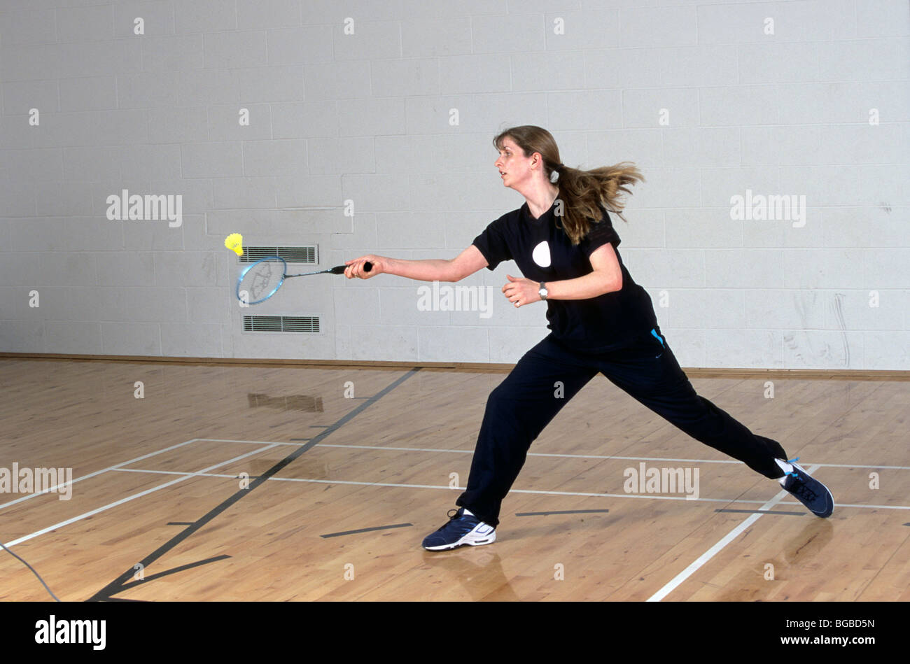 Woman playing badminton Stock Photo - Alamy
